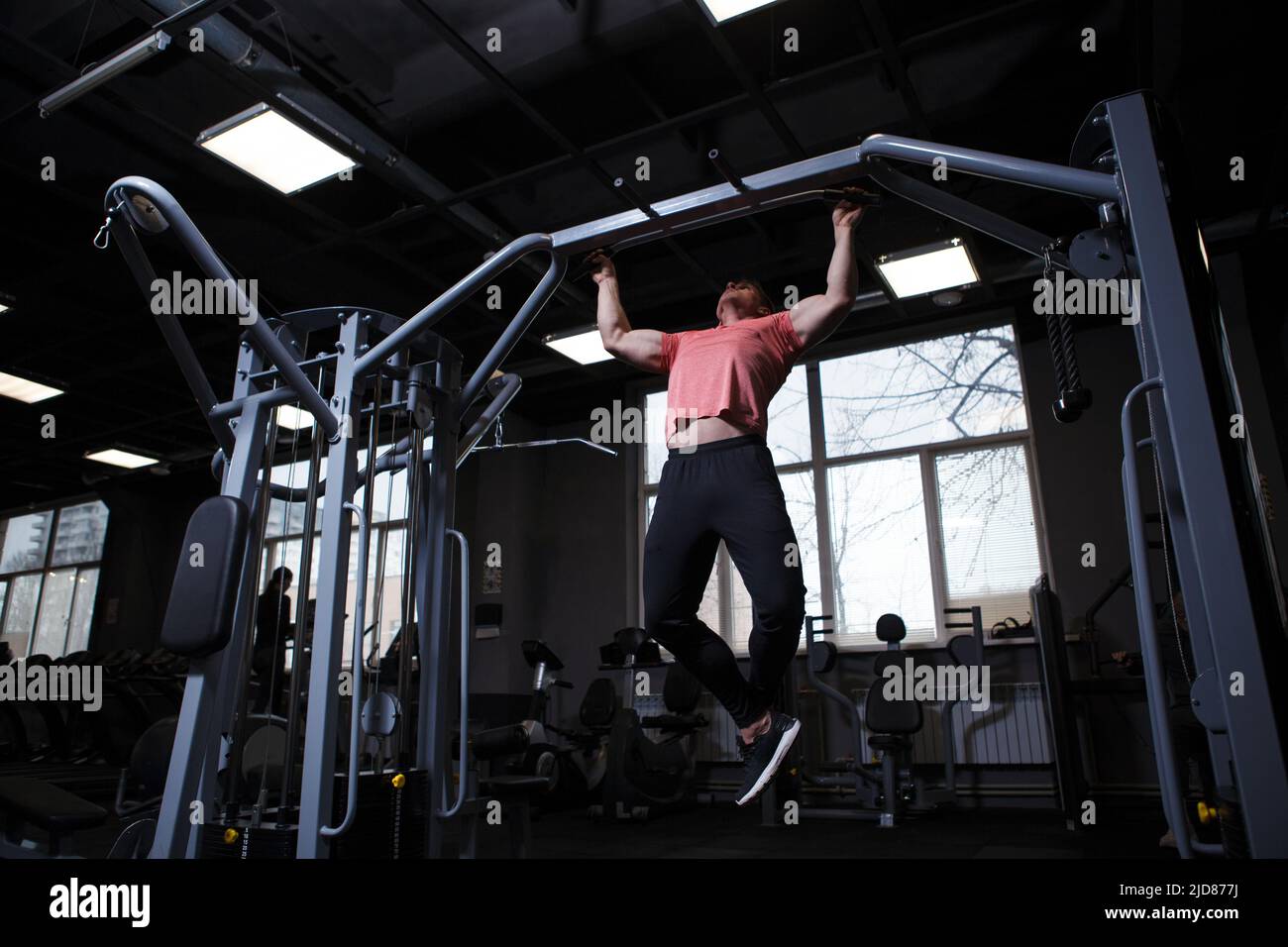 Low angle shot of a sportsman doing pull-ups at the gym Stock Photo - Alamy