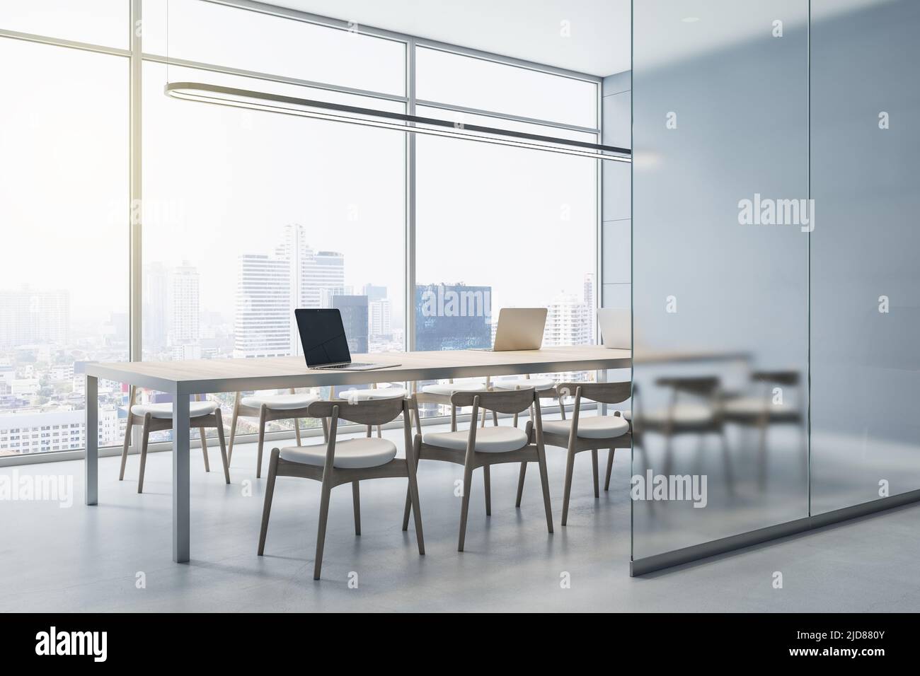 Side view on big stylish conference table surrounded by chairs in light ...