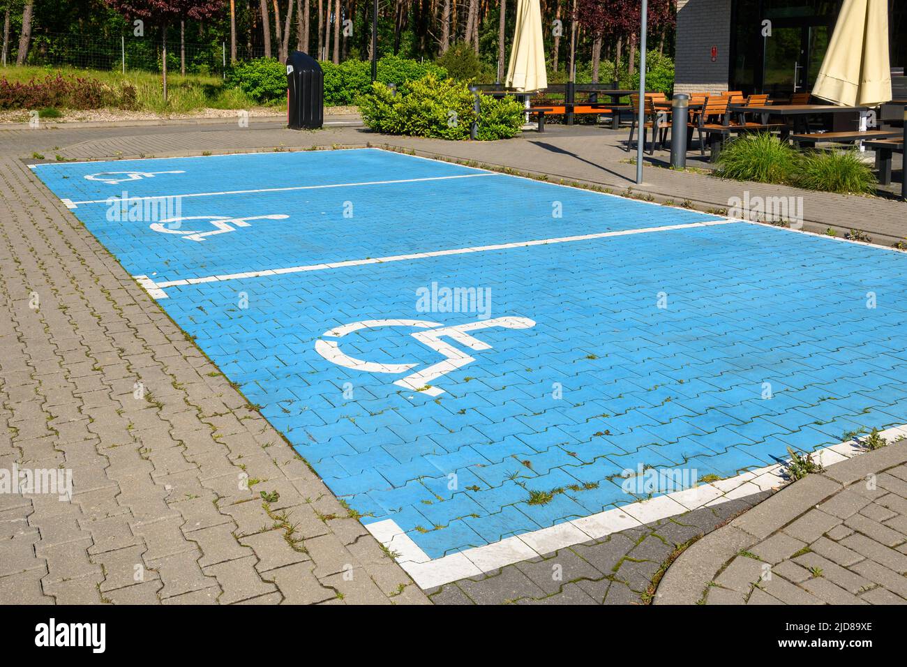 Disabled parking sign on the street. Wheelchair logo Stock Photo - Alamy
