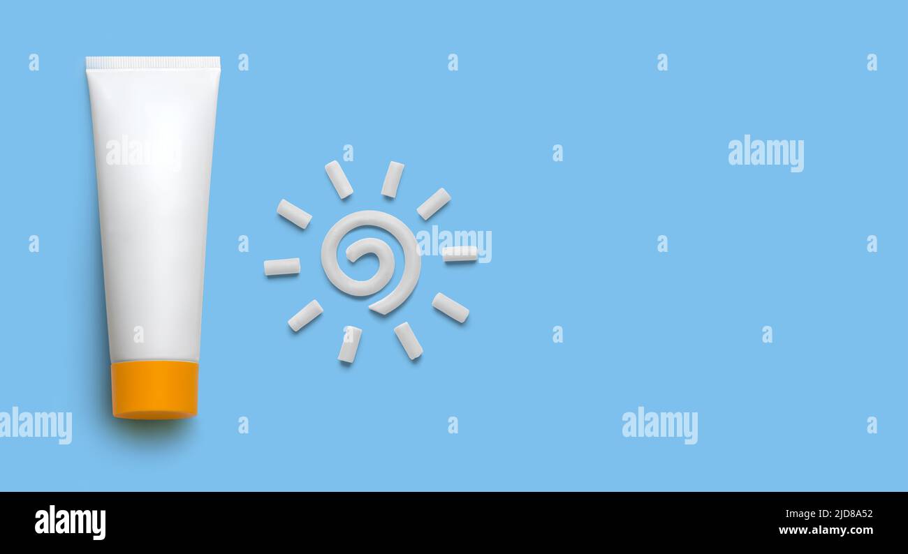 White blank cosmetic tube with sunscreen cream and plasticine sun on ...