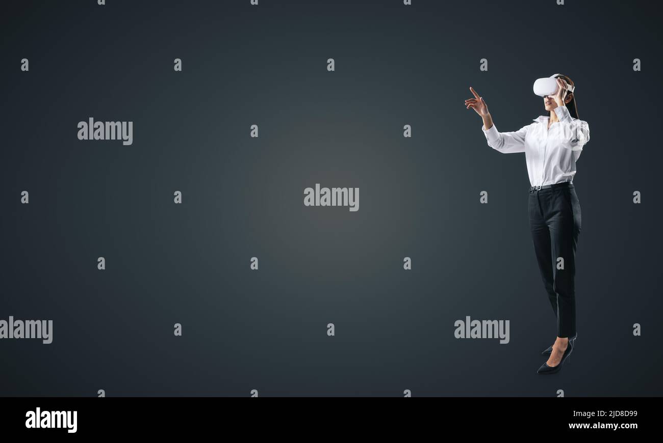 Woman full length standing and working in virtual reality environment ...