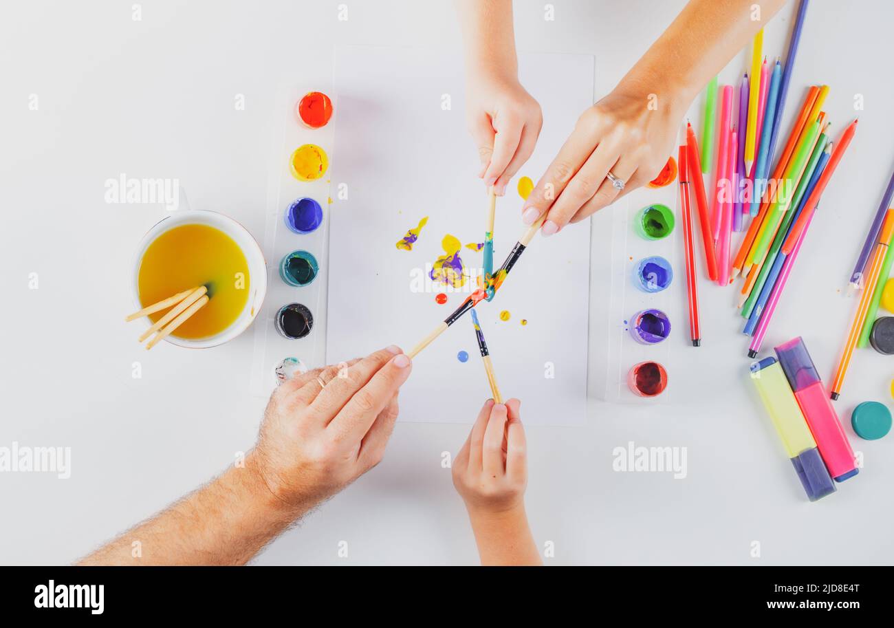 Fathers, mothers hands with children hands painting and drawing. Kids ...