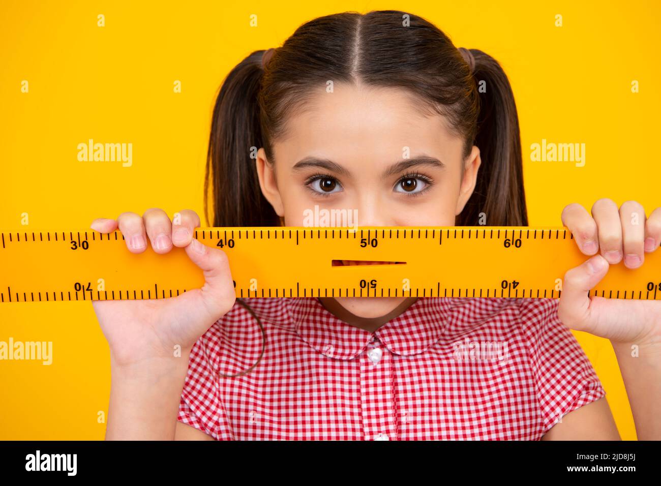 Measuring school equipment. Schoolgirl holding measure for geometry ...