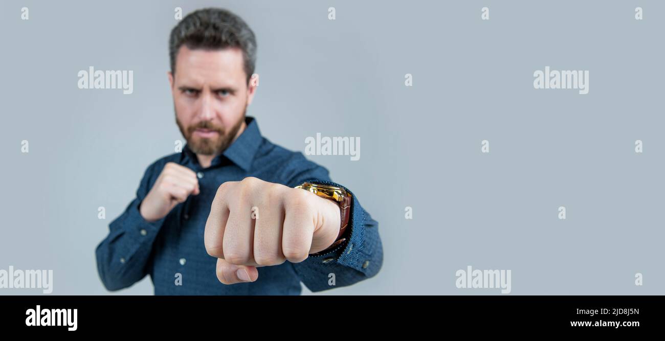 Mature man stand in offensive fighting position with clenched fist ...