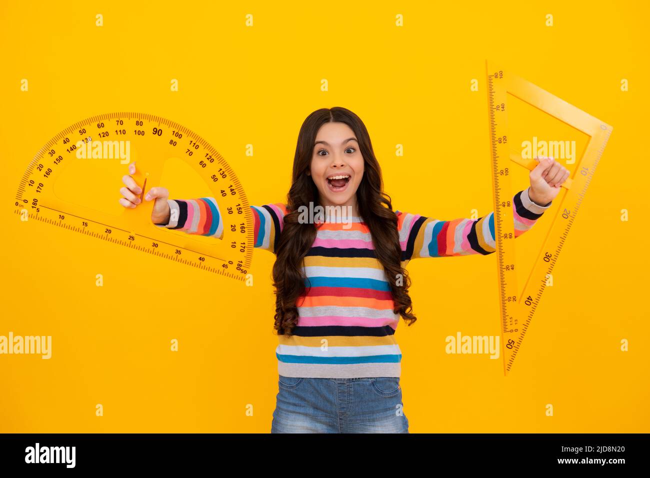 Amazed teenager. Back to school. School girl hold ruler measuring ...