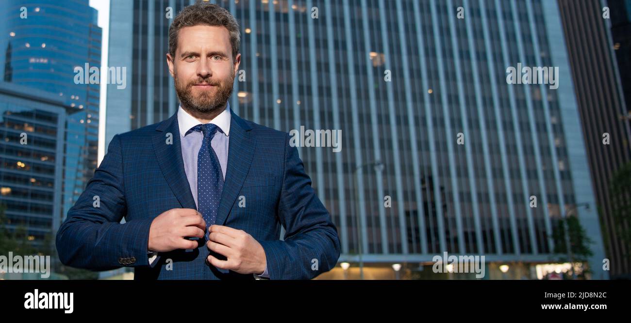 smiling entrepreneur in suit outside the office, copy space, business ...