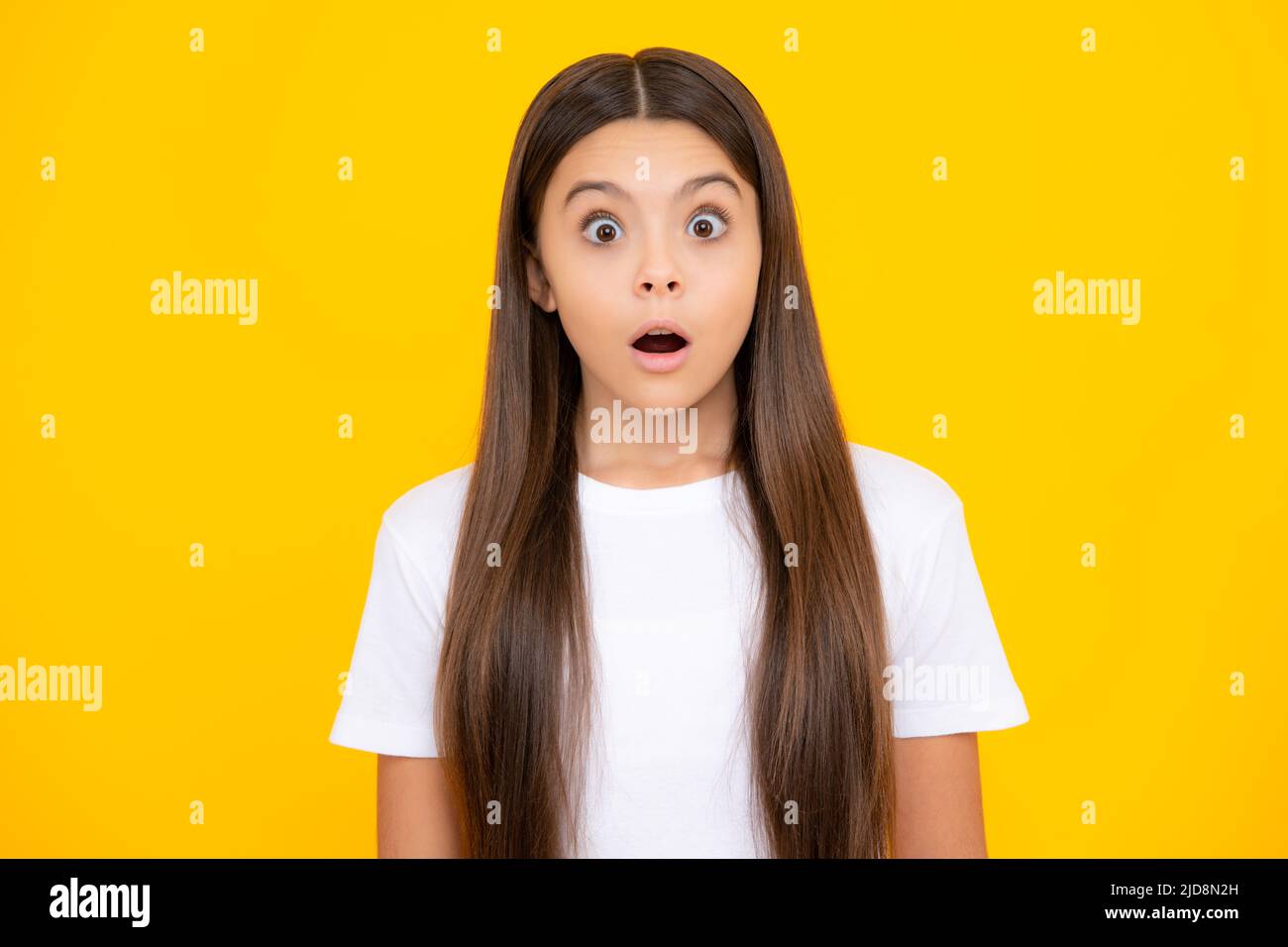 Shocked teenager child portrait isolated on yellow background ...