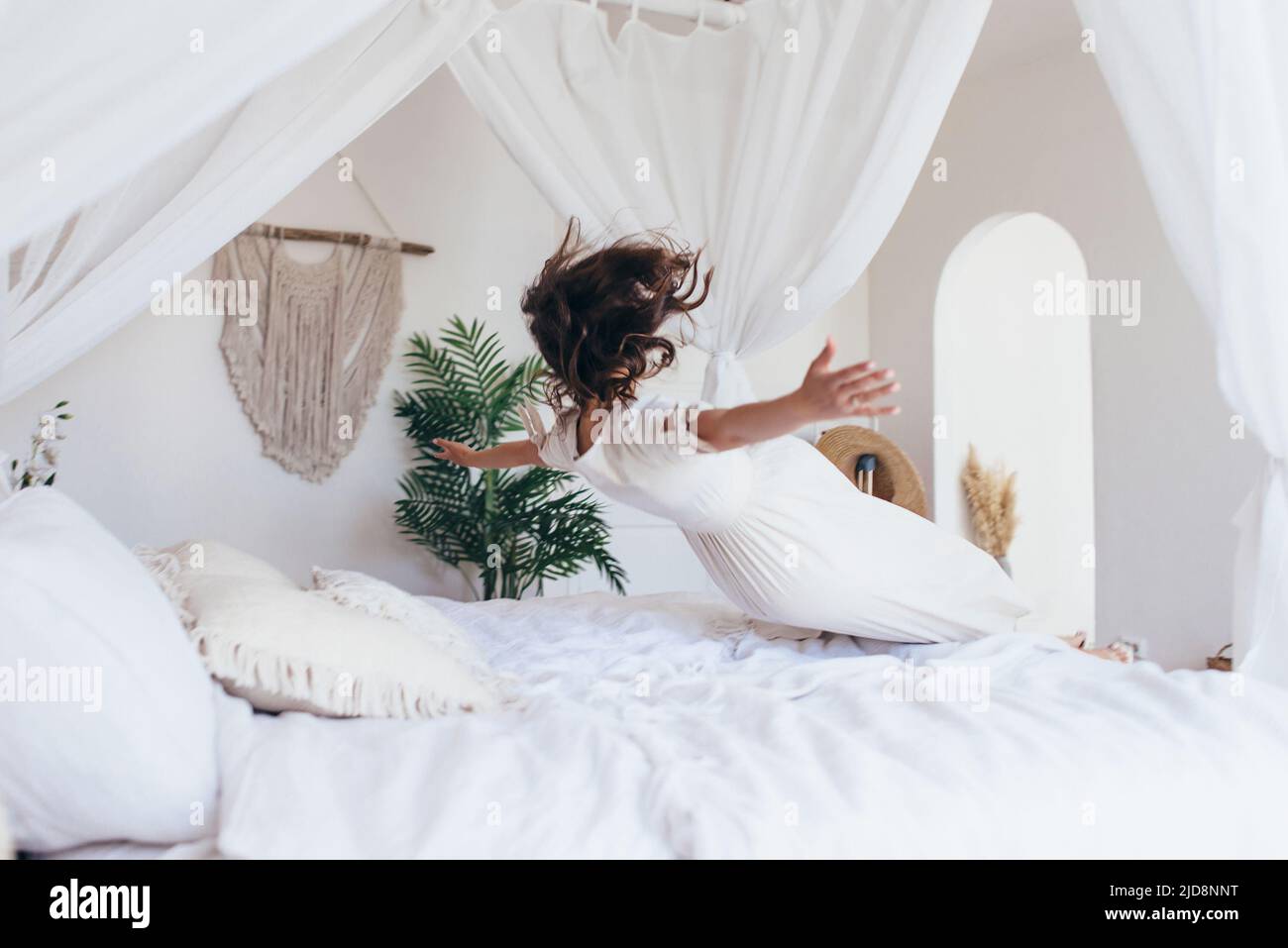 Woman falls on the bed Stock Photo - Alamy