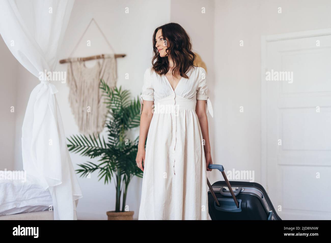 Female tourist looks around hotel room after checking in Stock Photo ...