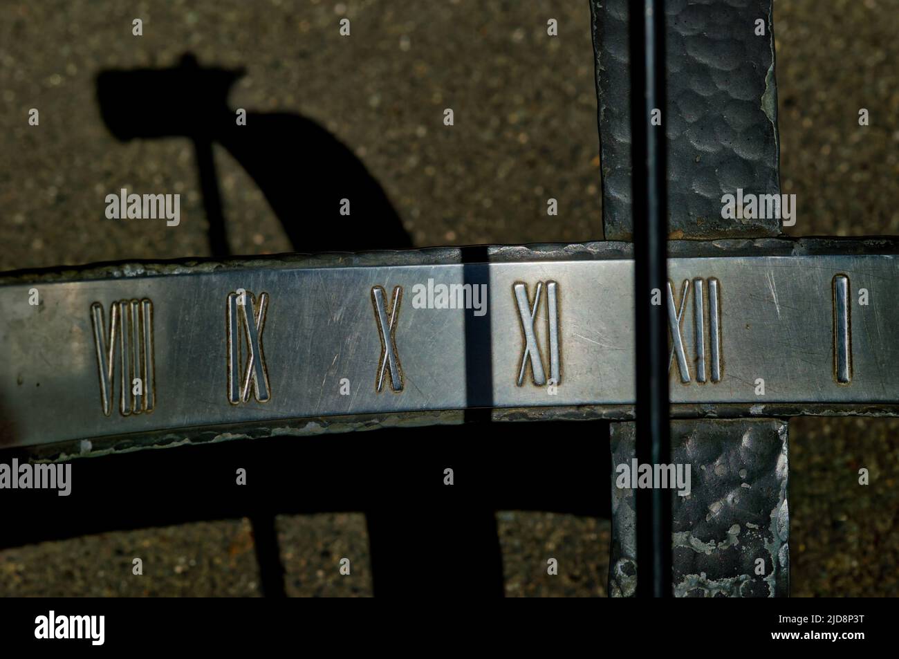 metallic sundial with roman numerals Stock Photo - Alamy