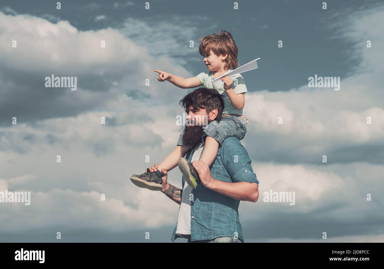 Father and son. Child sits on the shoulders of his father. Generation ...