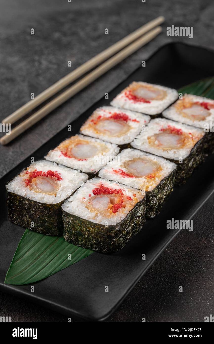 set of square maki rolls with tiger shrim, caviar and green bamboo leaf ...