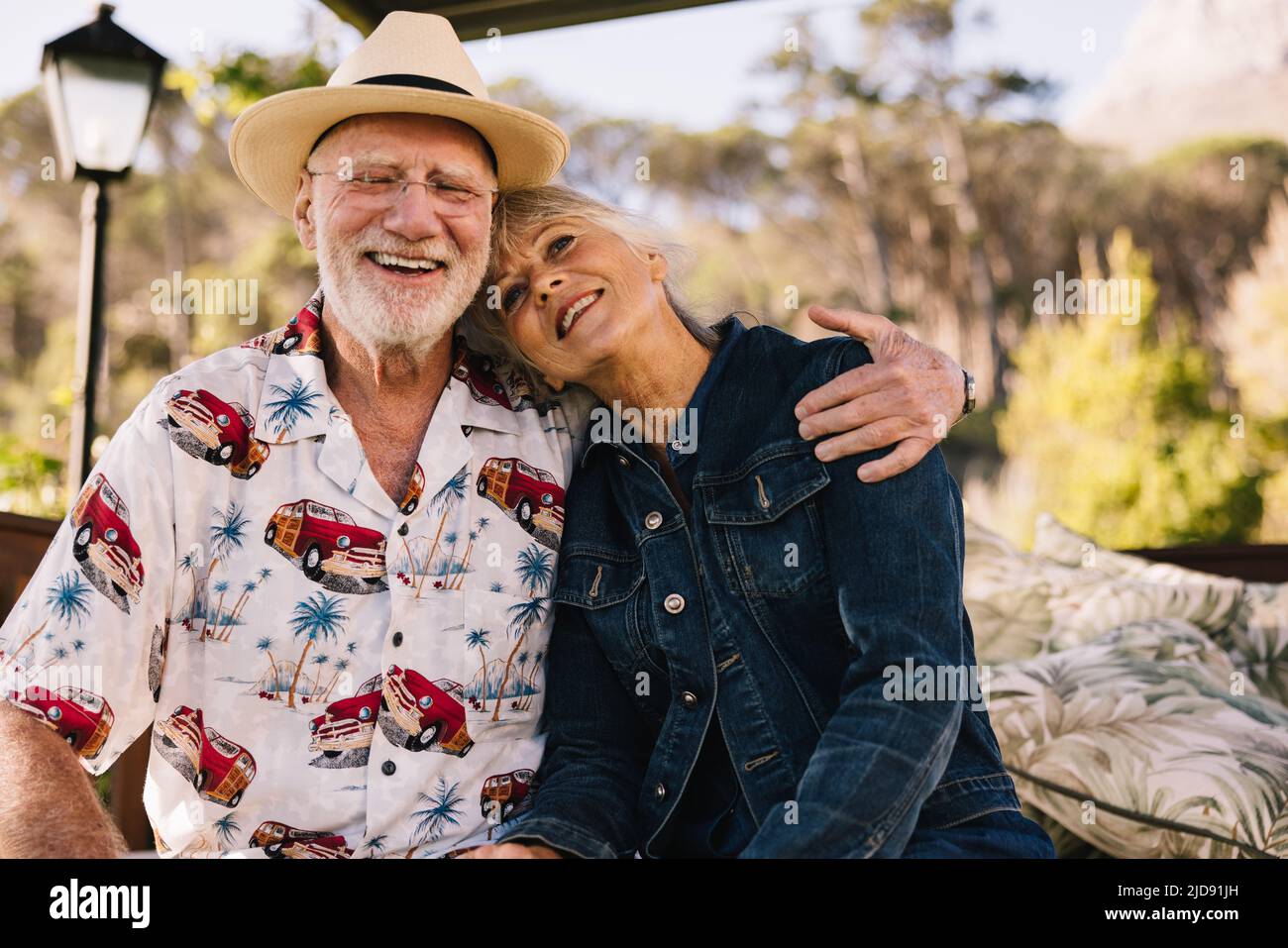 Romantic senior couple smiling cheerfully while relaxing at a spa ...