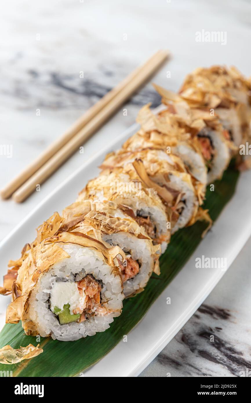 set of bonito rolls with grilled salmon, avocado, tuna shavings and ...