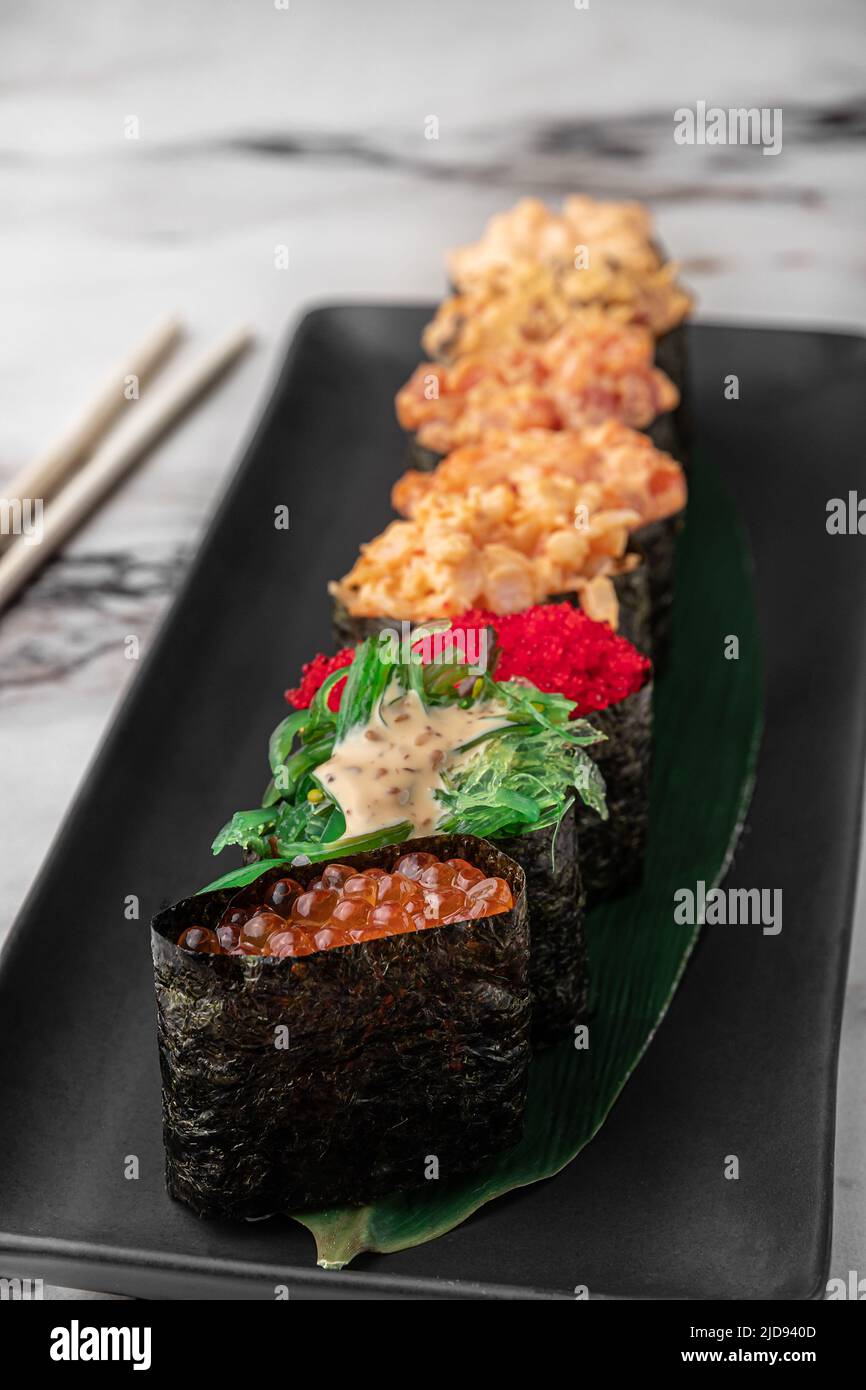 set of gunkan with salmon, chuka salad, flying fish roe, tuna and green ...