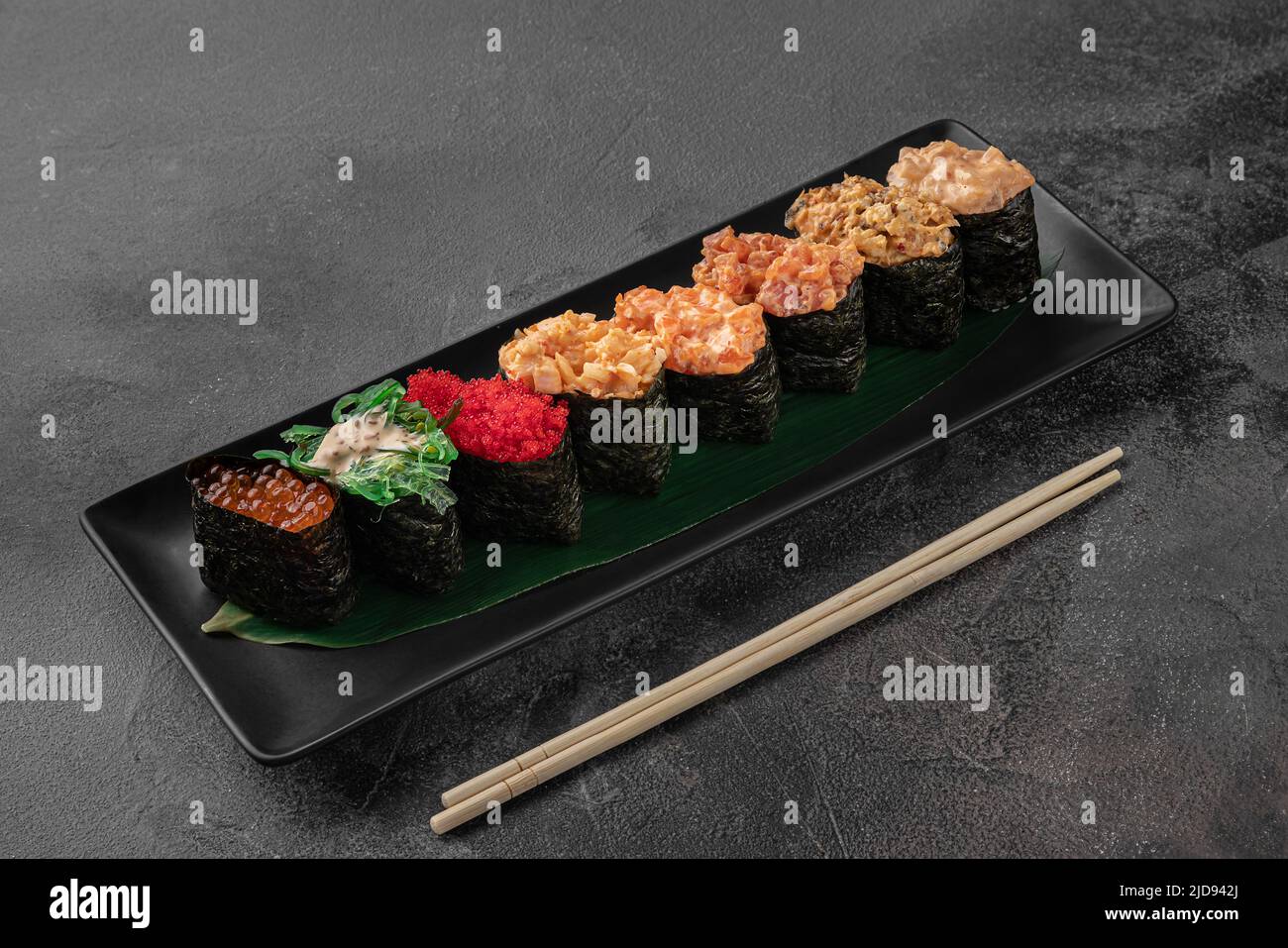set of gunkan with salmon, chuka salad, flying fish roe, tuna and green ...