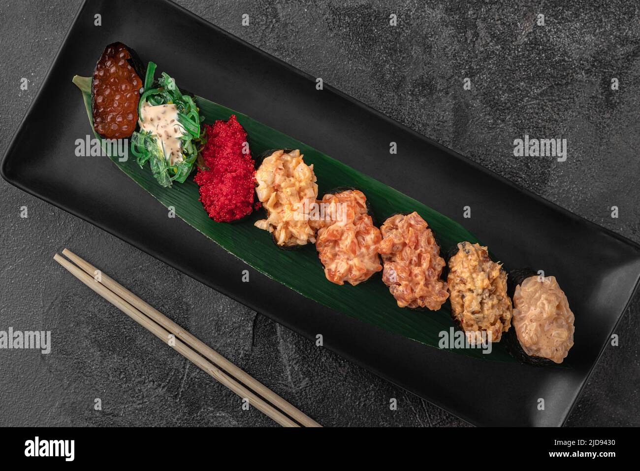 set of gunkan with salmon, chuka salad, flying fish roe, tuna and green ...