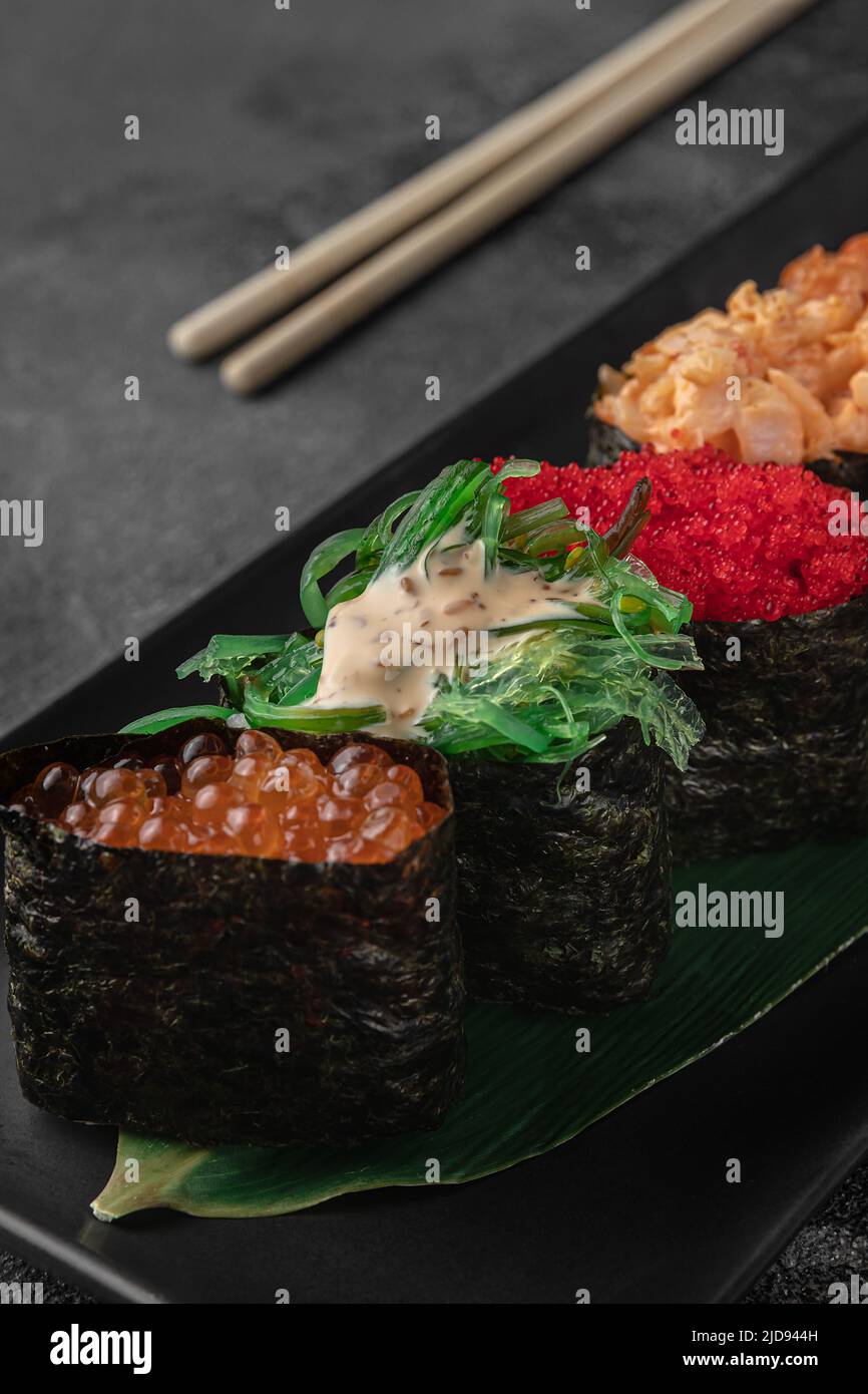 set of gunkan with salmon, chuka salad, flying fish roe, tuna and green ...