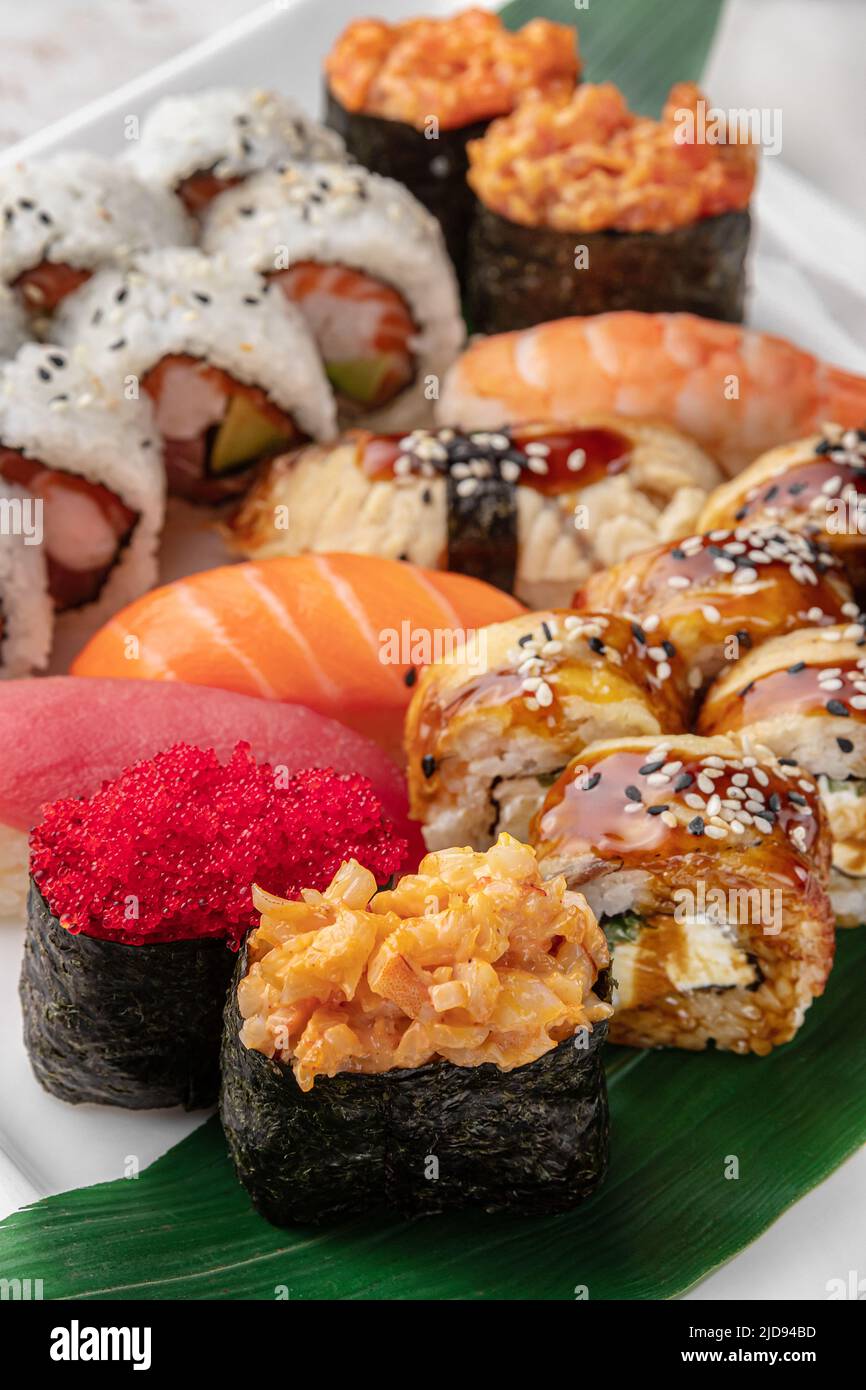 set of different colorful maki sushi rolls, nigiri and gunkan with ...