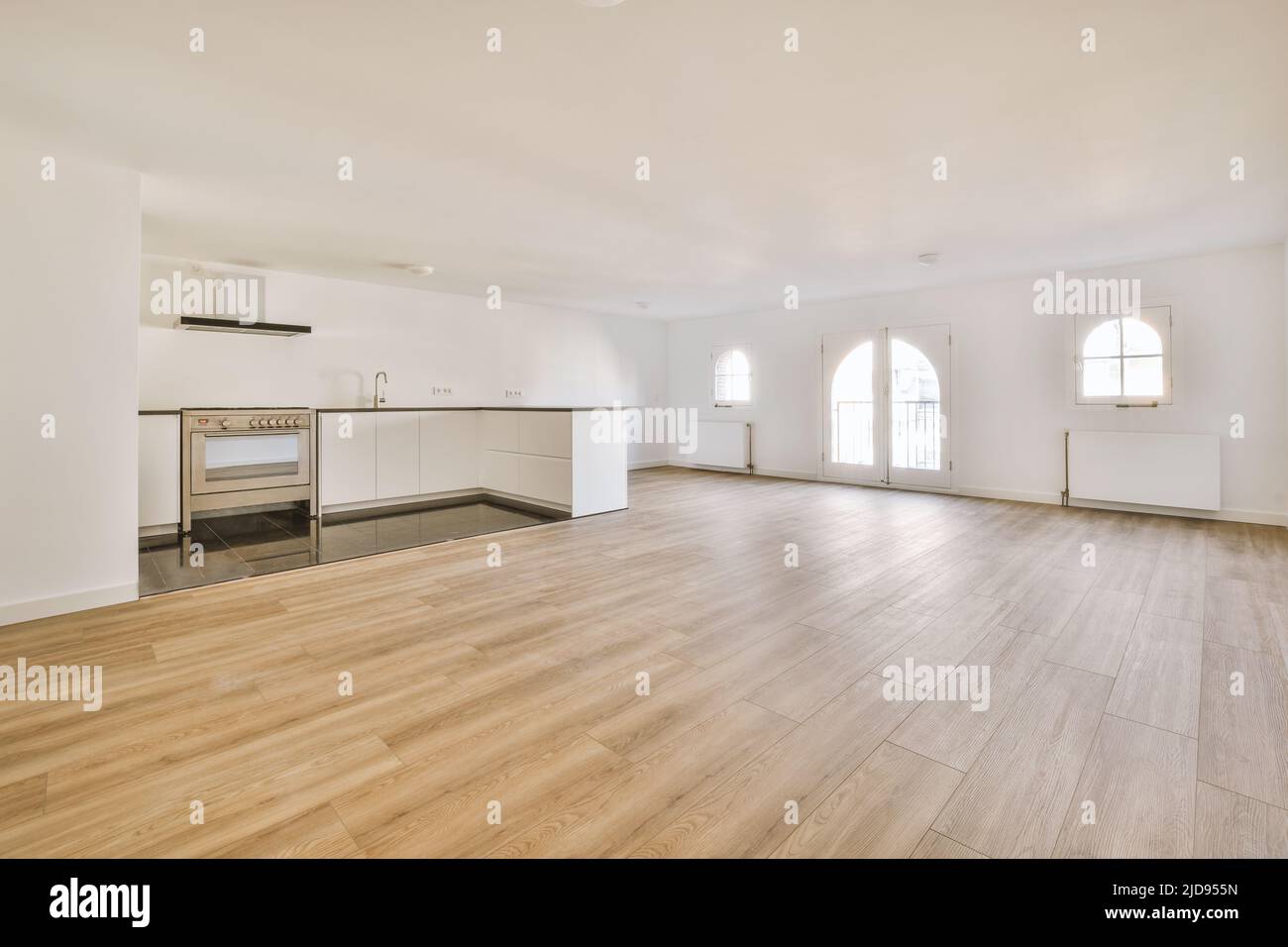 Interior of empty white kitchen with corridor and wooden parquet floor ...