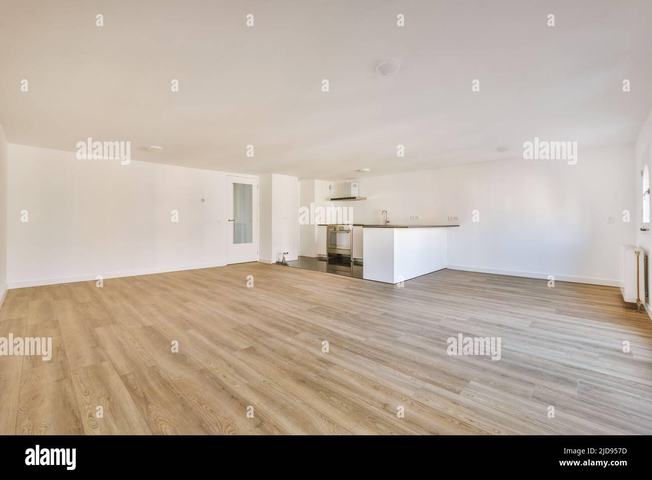 Interior of empty white kitchen with corridor and wooden parquet floor ...