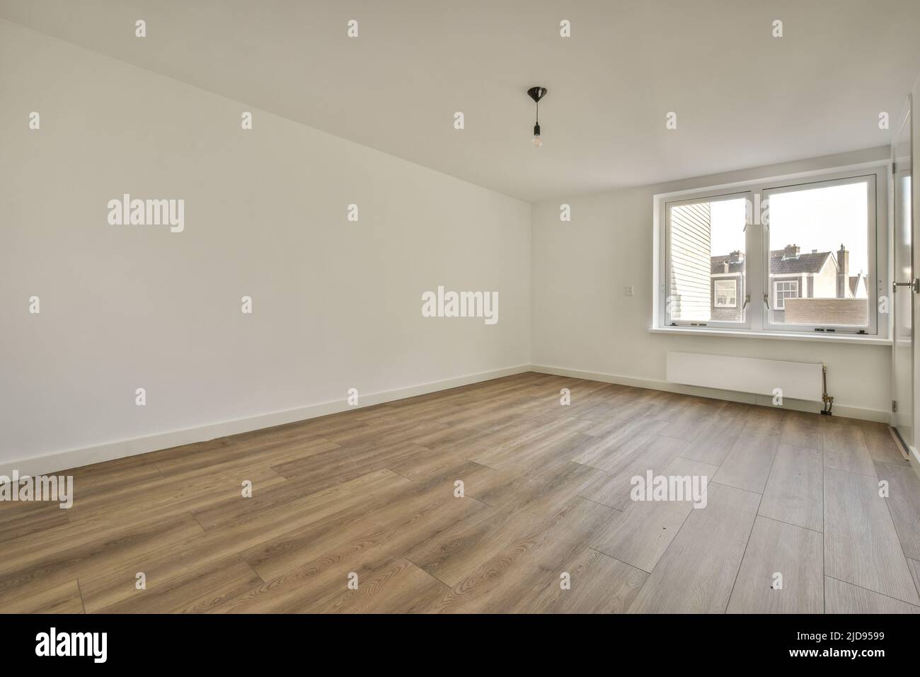 Plastic window and radiator on white wall in empty light room at home ...