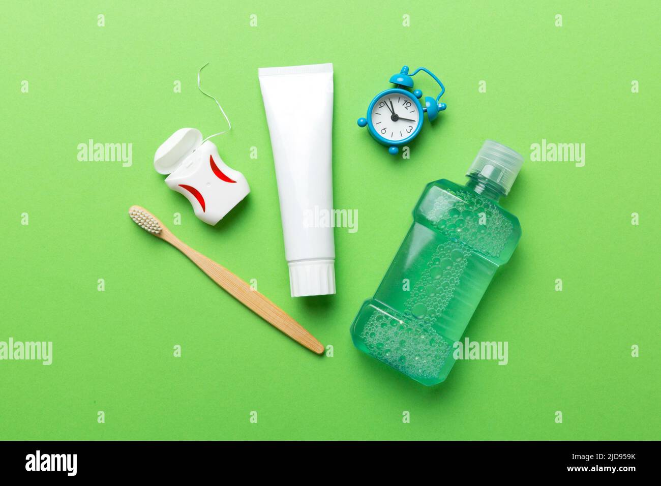 Mouthwash and other oral hygiene products on colored table top view ...