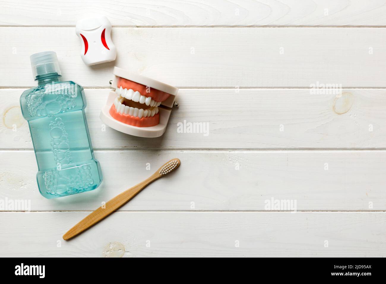 Mouthwash and other oral hygiene products on colored table top view ...