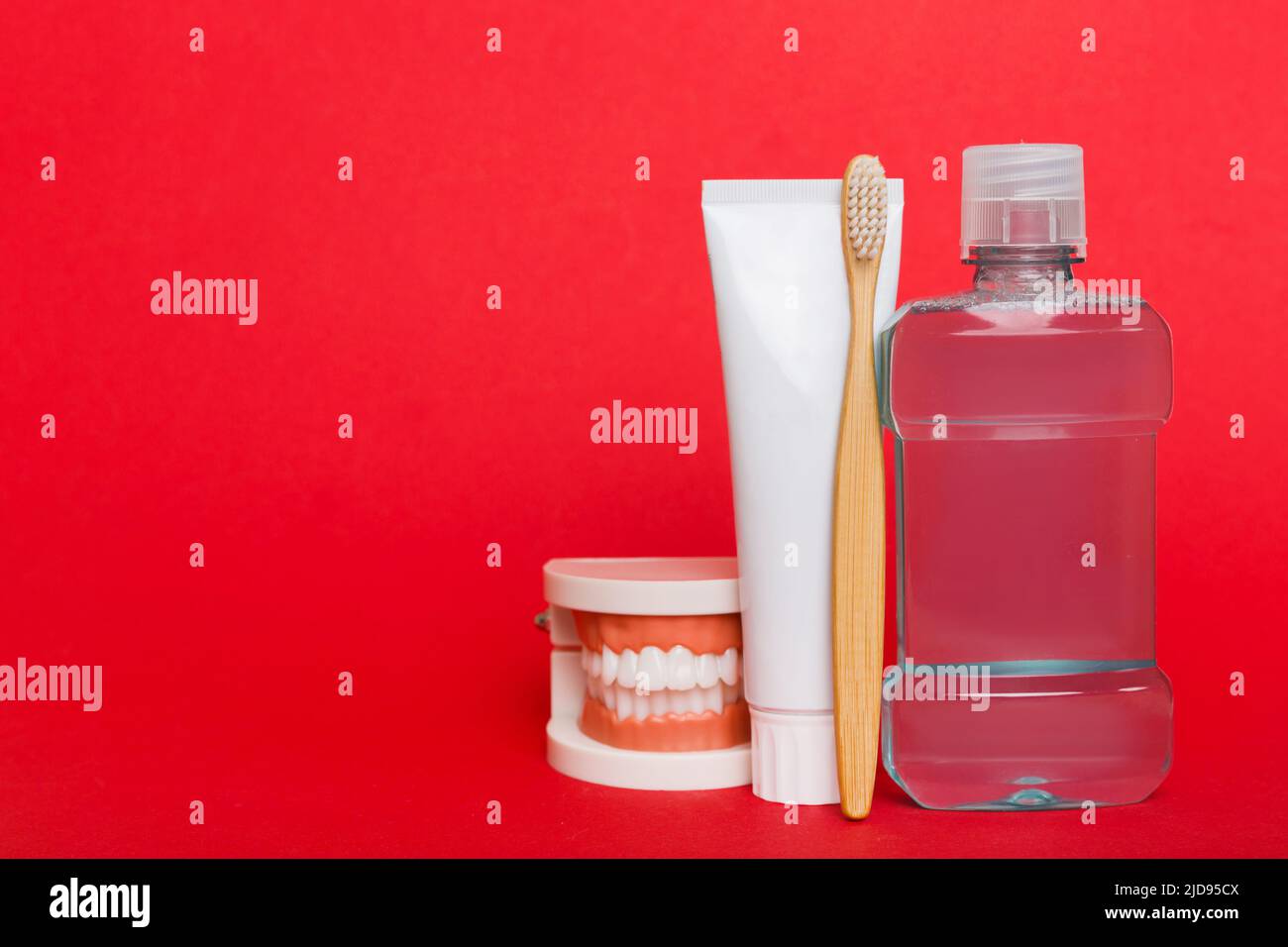 Mouthwash and other oral hygiene products on colored table top view ...