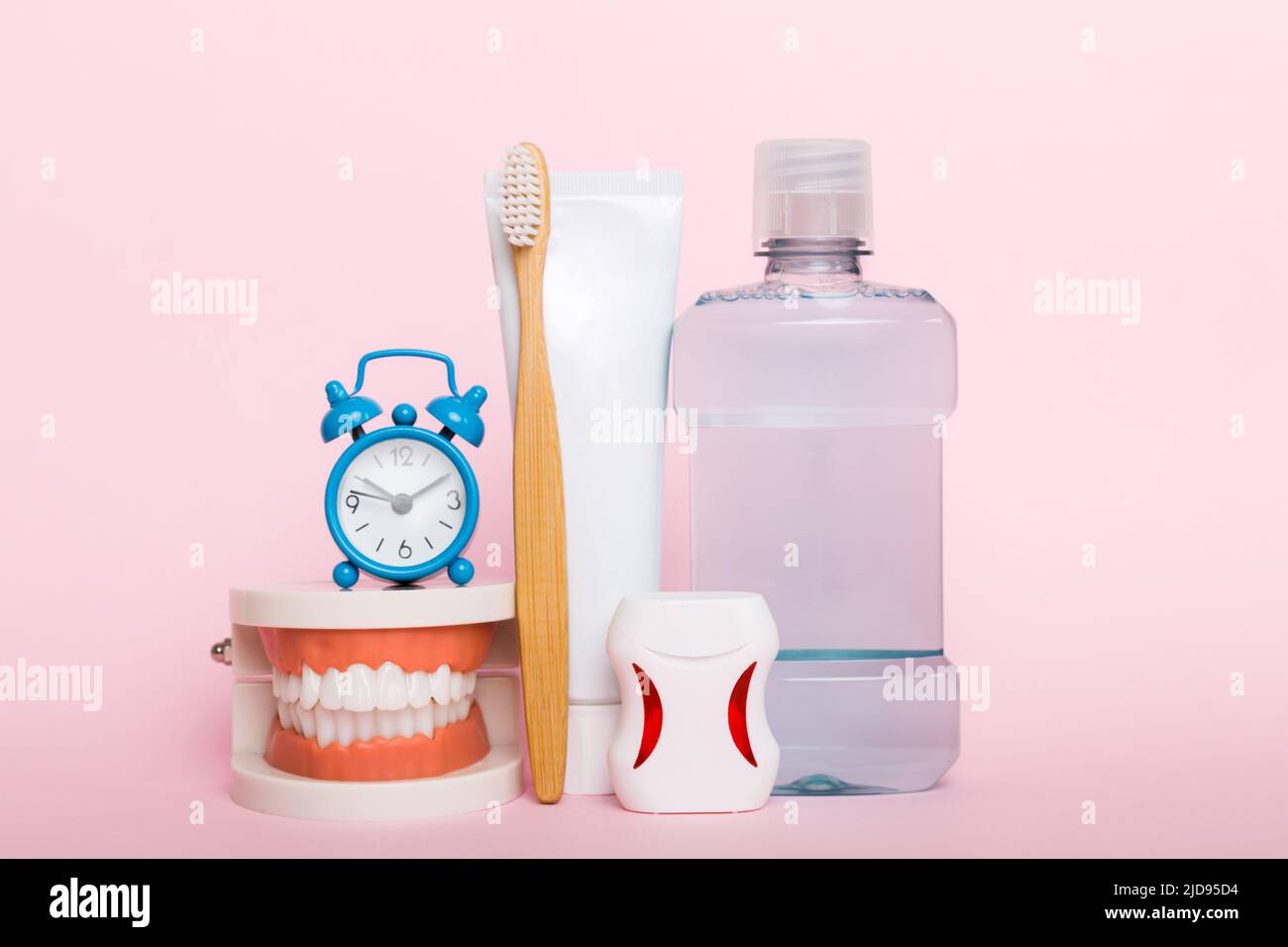 Mouthwash and other oral hygiene products on colored table top view ...