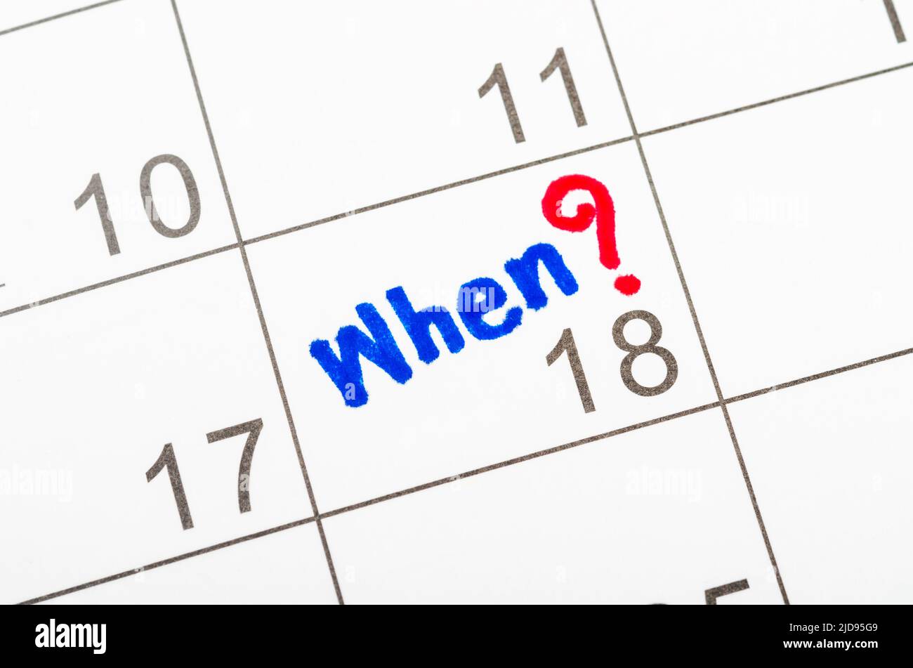 The Hand writing When and Question mark sign on desk calendar page ...