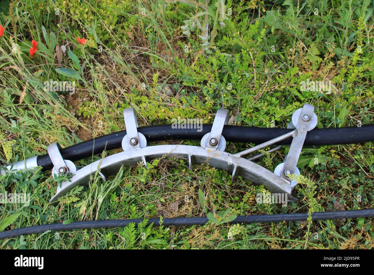 Deflection roller for guiding a hose in the duct Stock Photo - Alamy