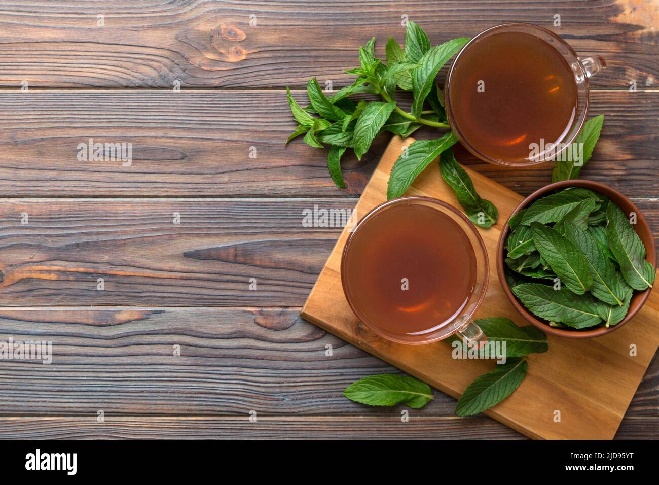 Cup of mint tea on table background. Green tea with fresh mint top view ...