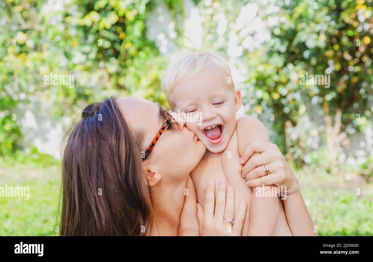 Happy child son hug mom. Family mother and boy smiling and hugging ...