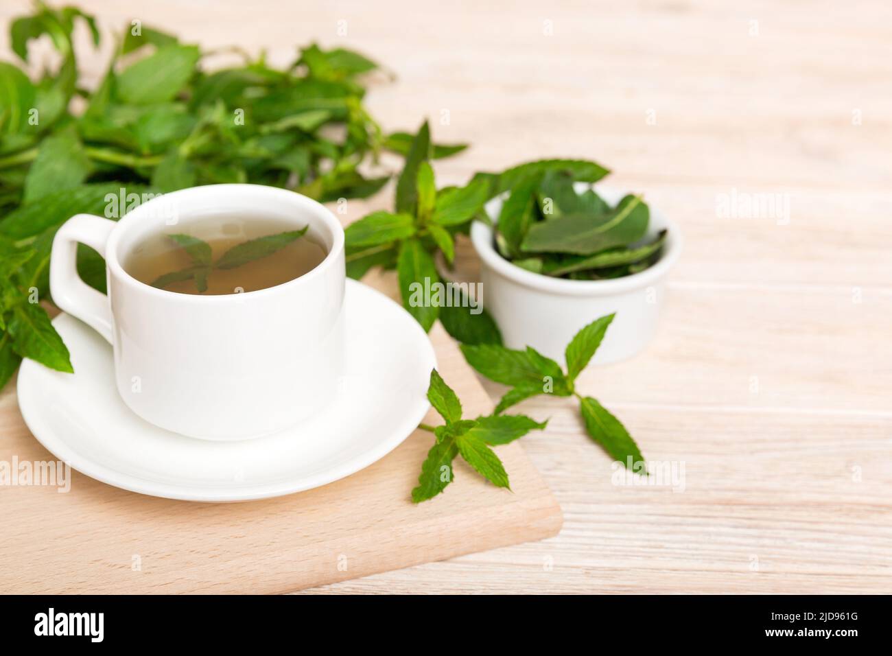 Cup of mint tea on table background. Green tea with fresh mint top view ...