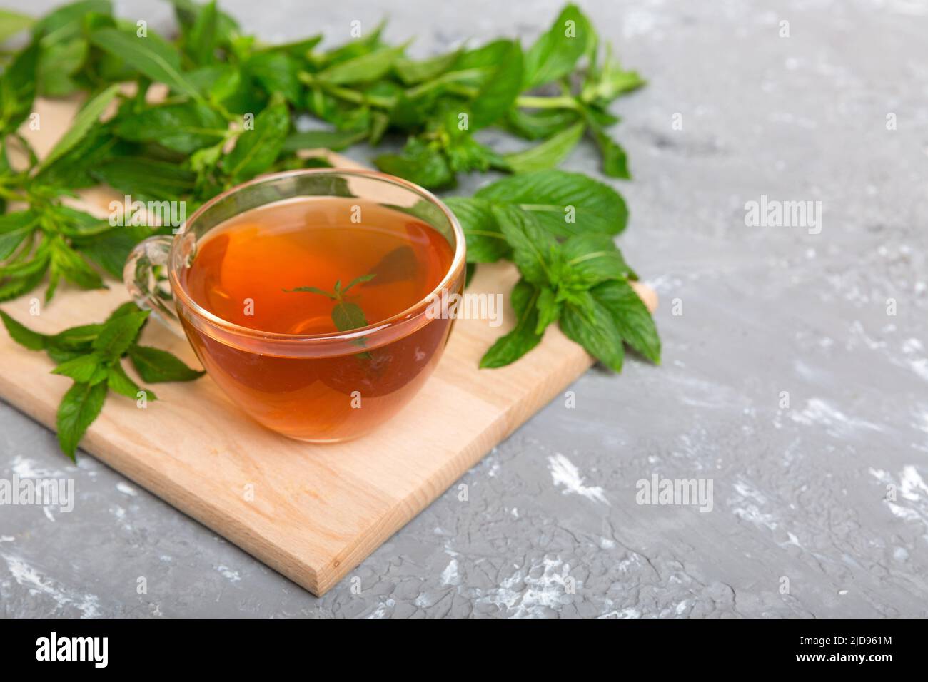 Cup of mint tea on table background. Green tea with fresh mint top view ...