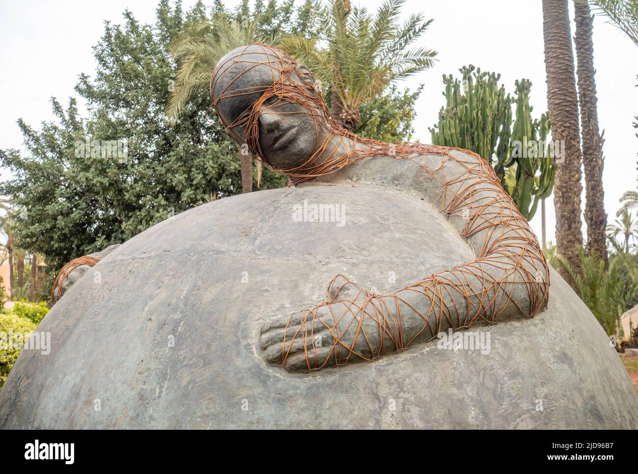 Sculpture - Man in a wire holding hugging a globe Marrakech, Morocco ...
