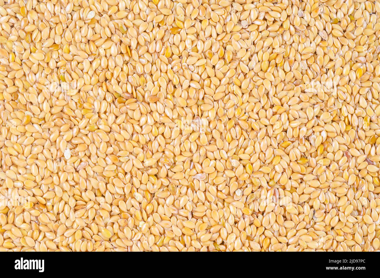 The Gold flax seeds texture as background Stock Photo - Alamy