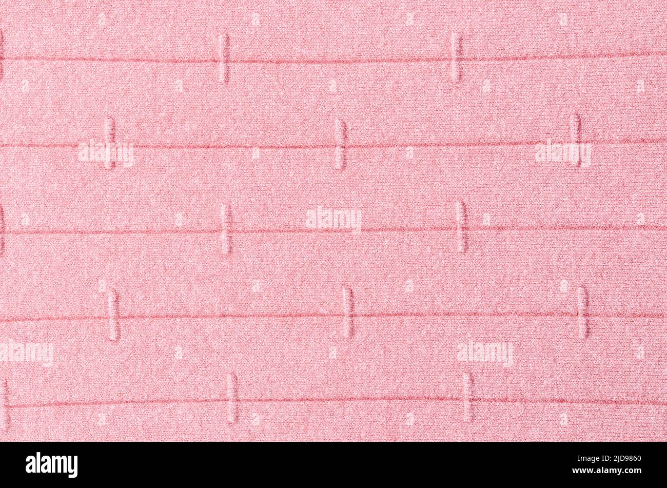 The Light pink background from a textile material pattern, closeup ...