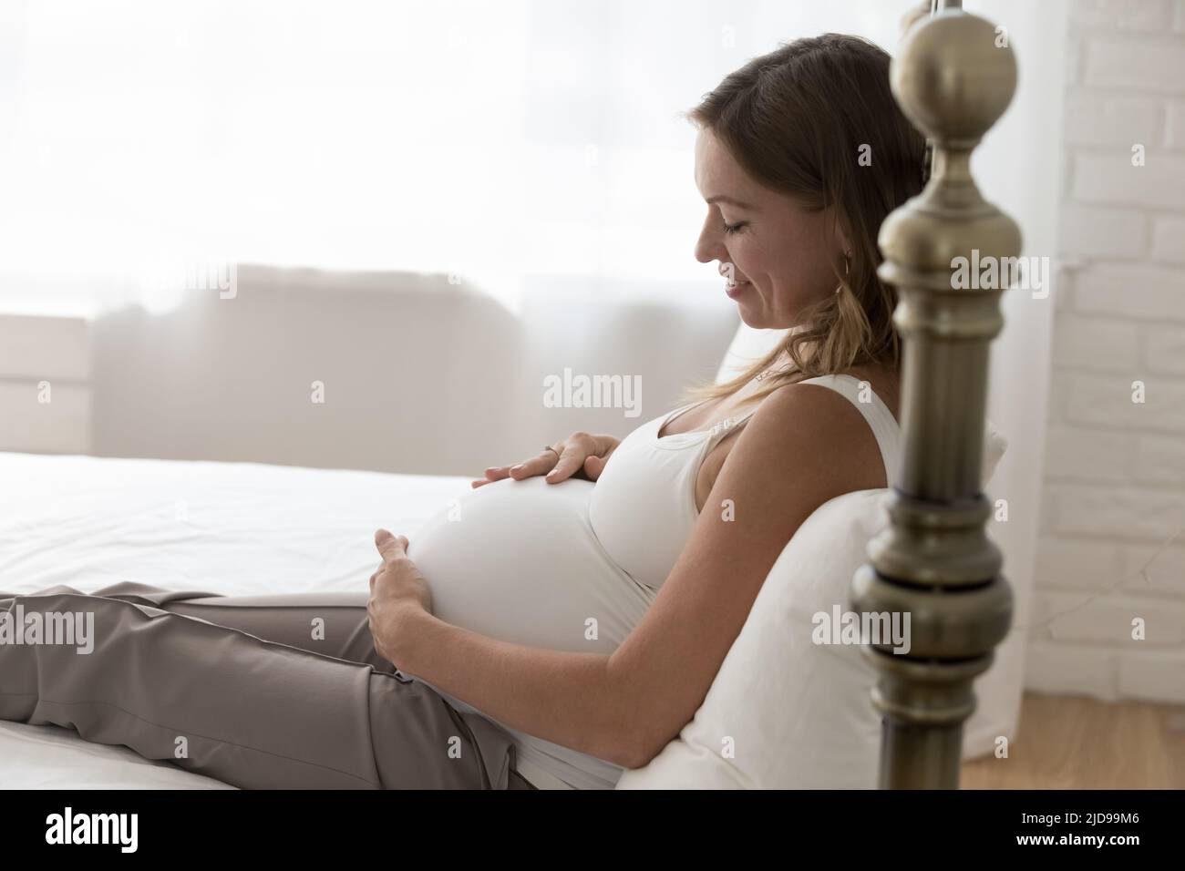 Young pregnant woman touch her big belly feeling love Stock Photo - Alamy