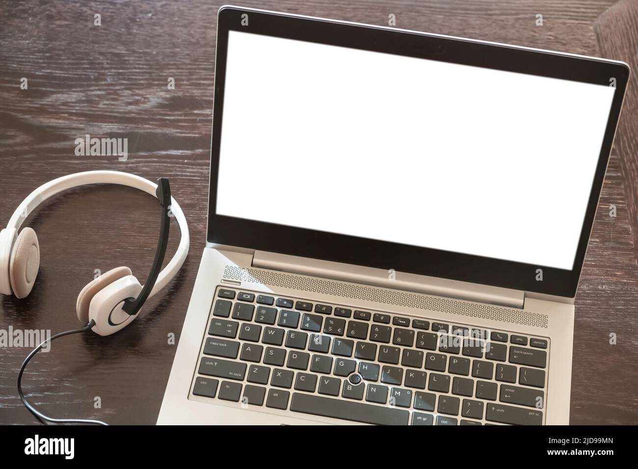 Headset on a laptop, blank white screen, wooden table background, Call ...