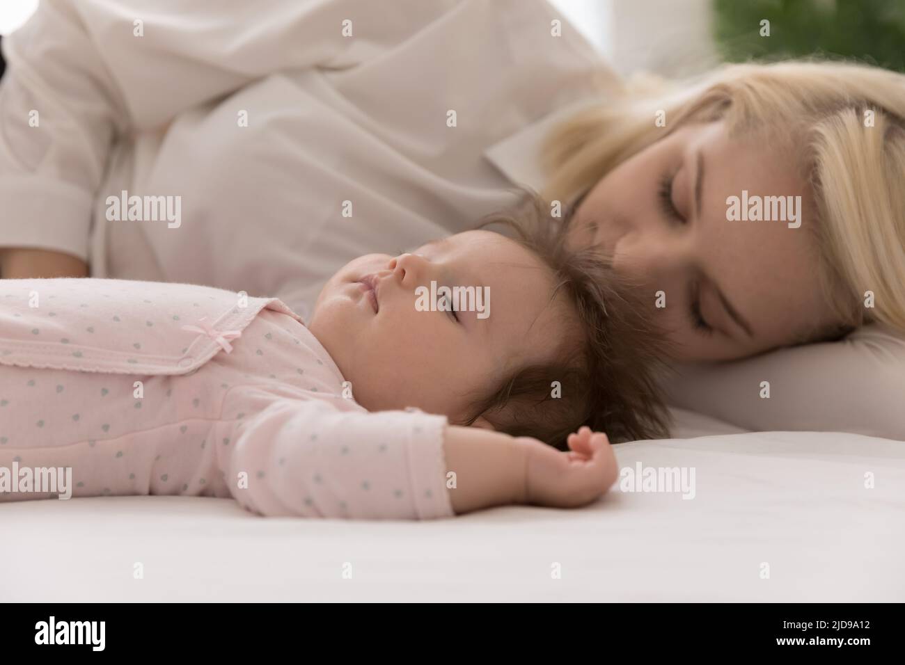 Close up shot peaceful baby and mother sleeping in bed Stock Photo - Alamy