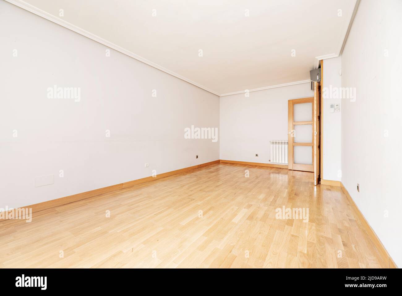 Empty living room with oak parquet and wooden doors of the same ...