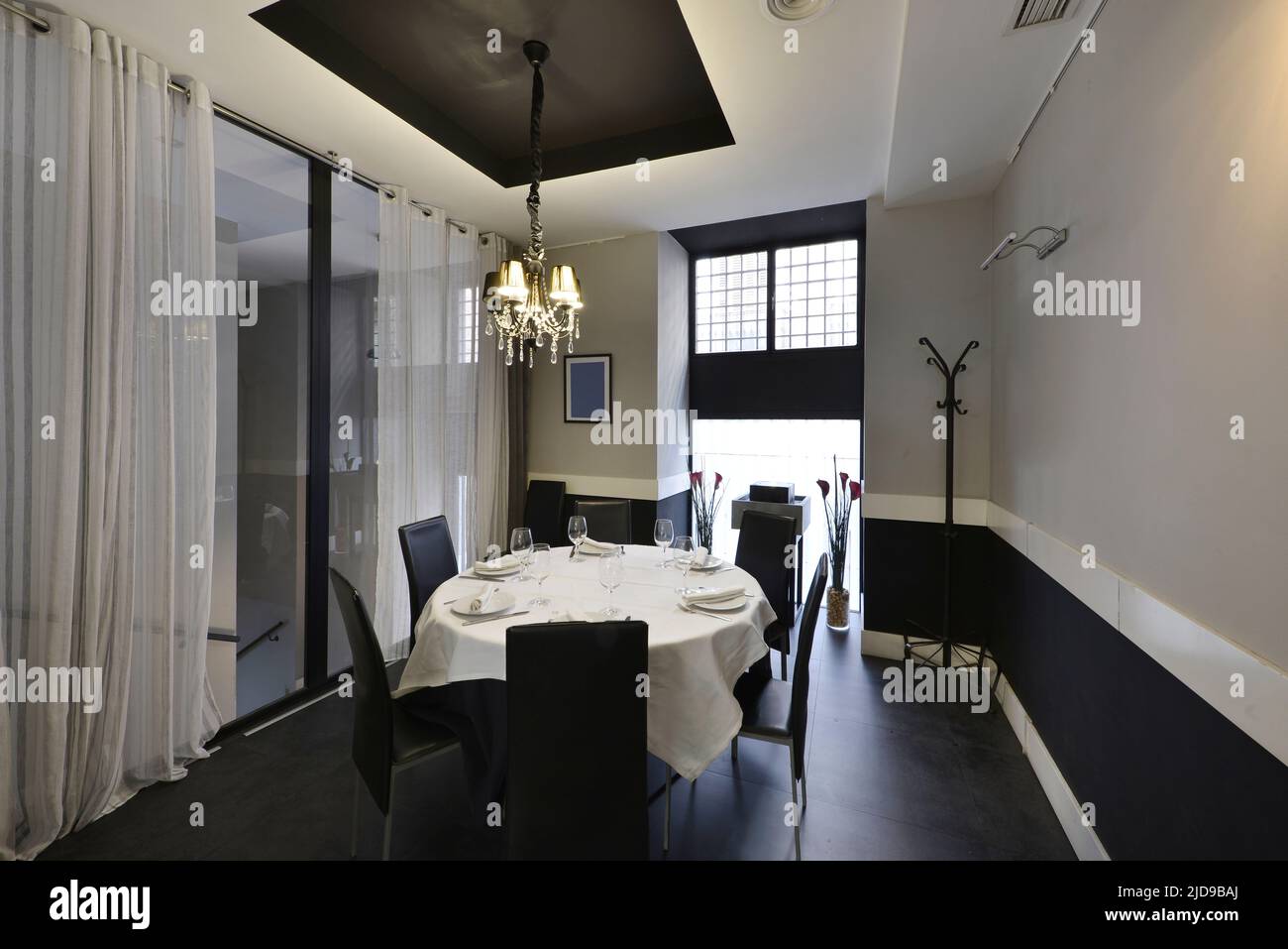 Reserved dining room of a restaurant with a round table with dishes, a ...