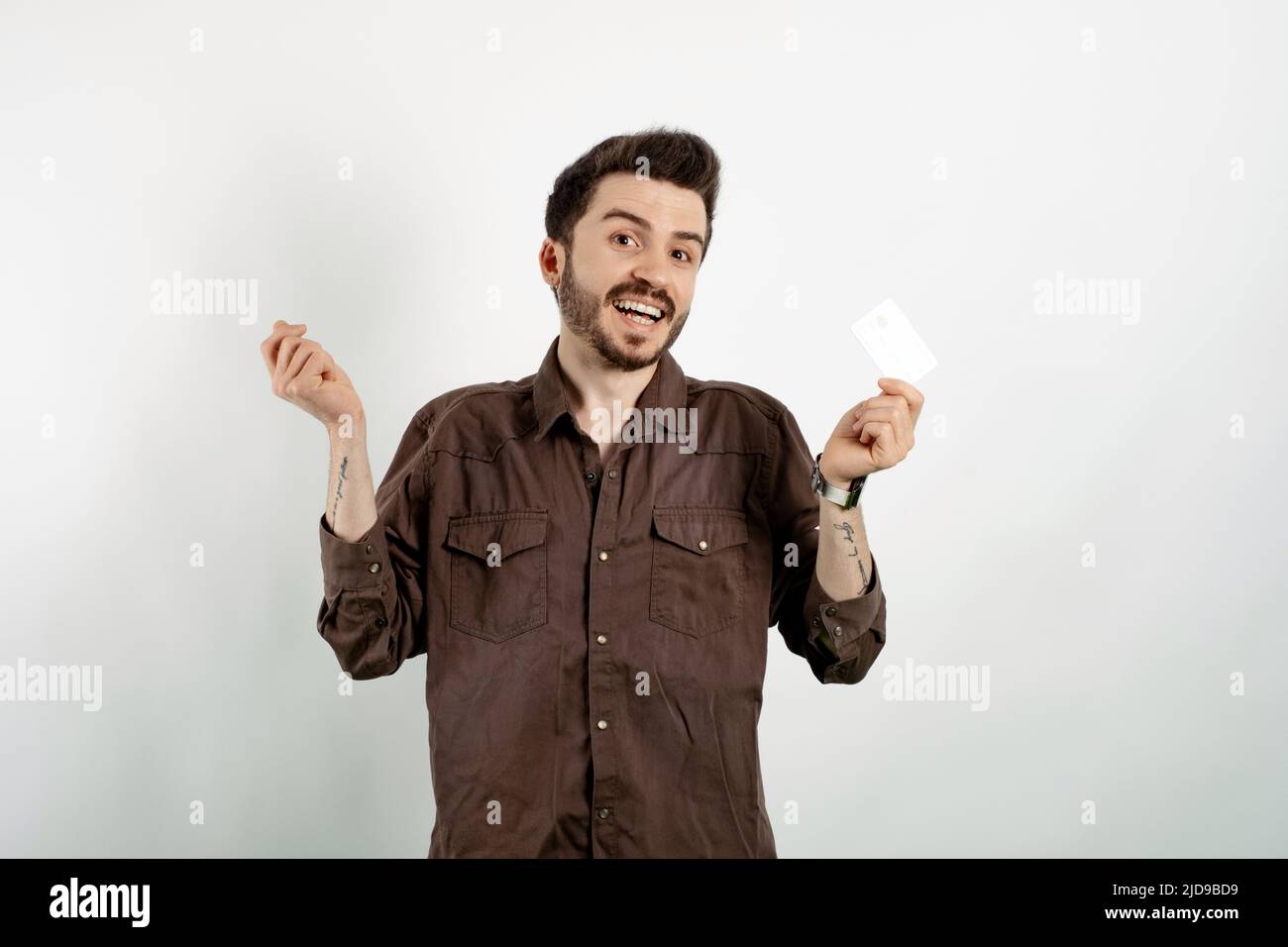 Cheerful caucasian man wearing brown shirt posing isolated over white ...