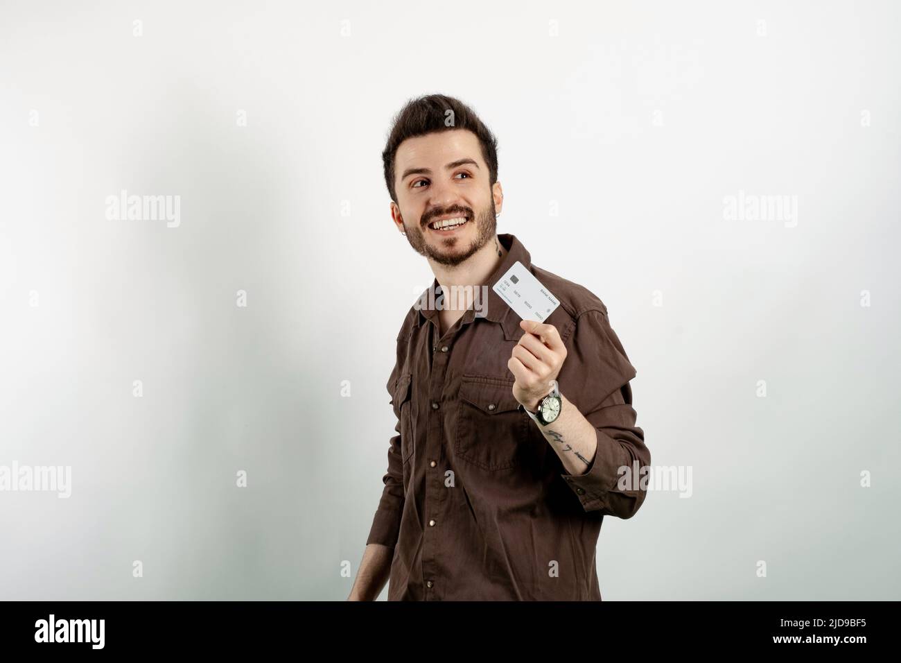 Cheerful caucasian man wearing brown shirt posing isolated over white ...