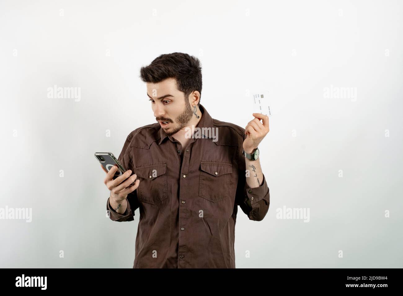 Caucasian man wearing brown shirt posing isolated over white background ...