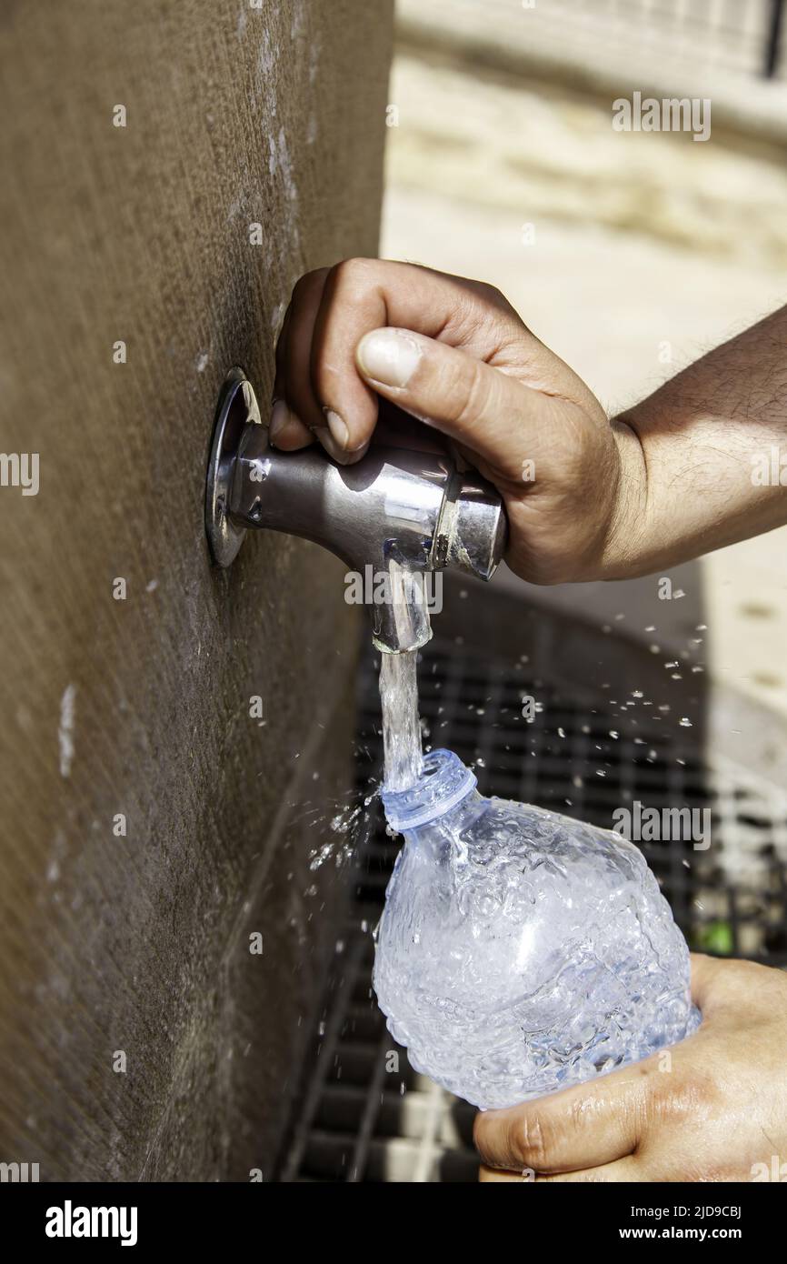 Filling water bottle in fountain, water and summer, refreshment Stock ...