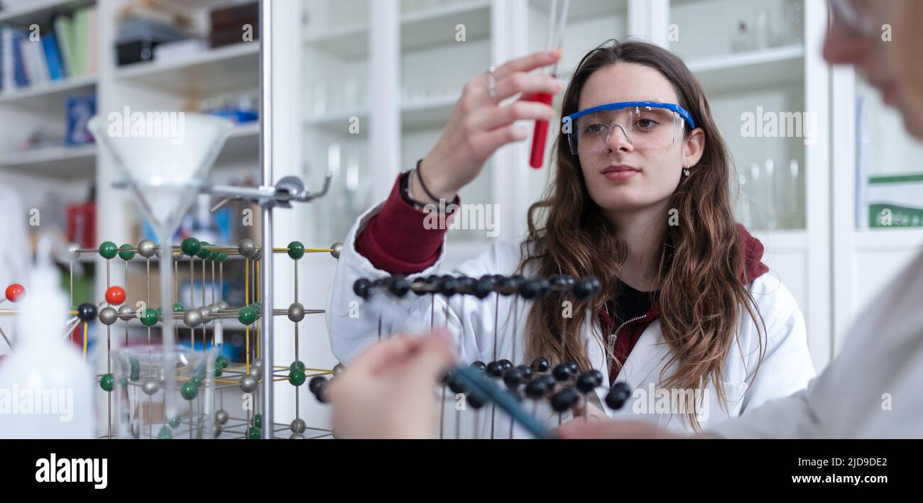 Science students doing chemical experiment in the laboratory at ...