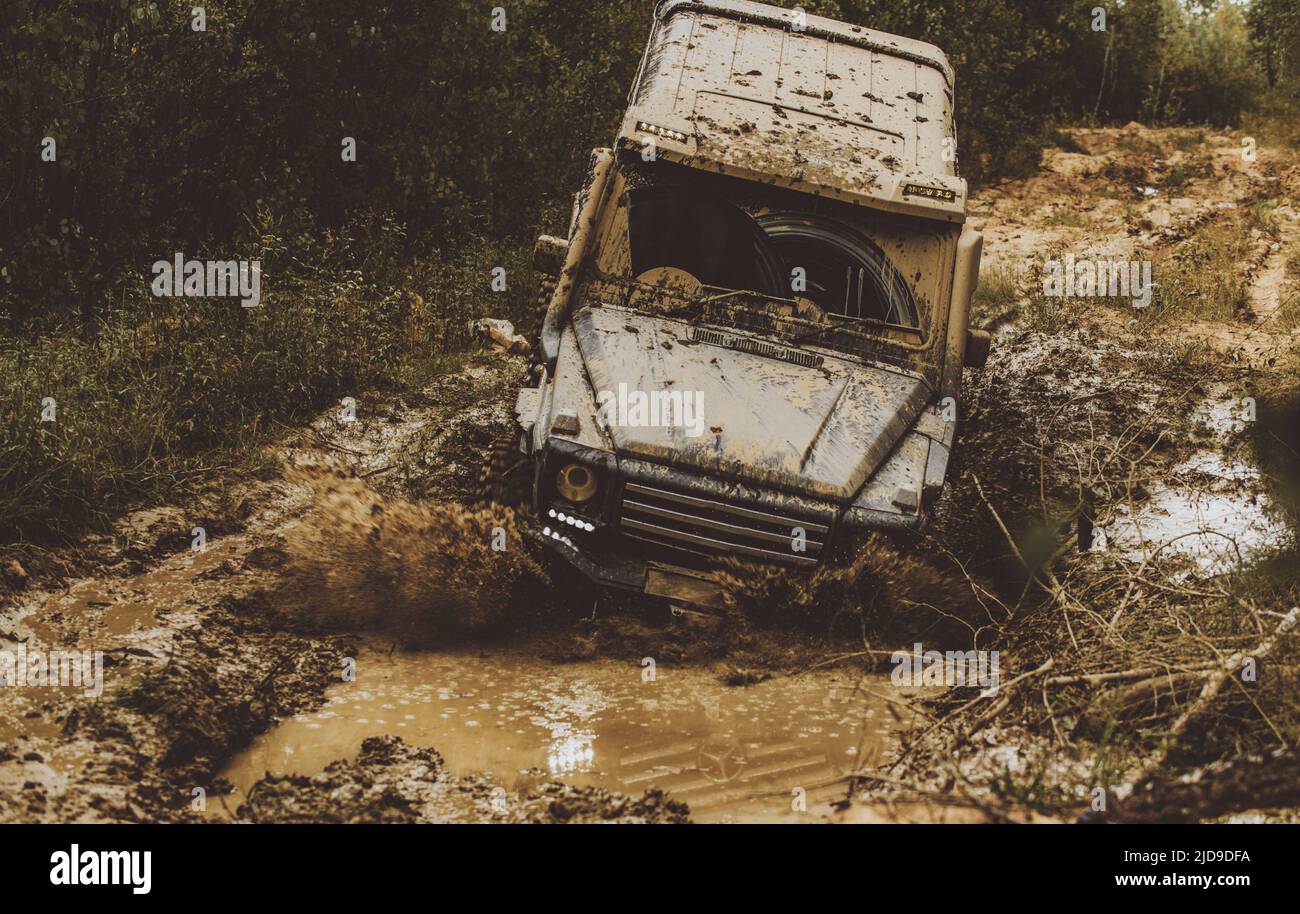 Mud and water splash in off the road racing. Tracks on a muddy field ...